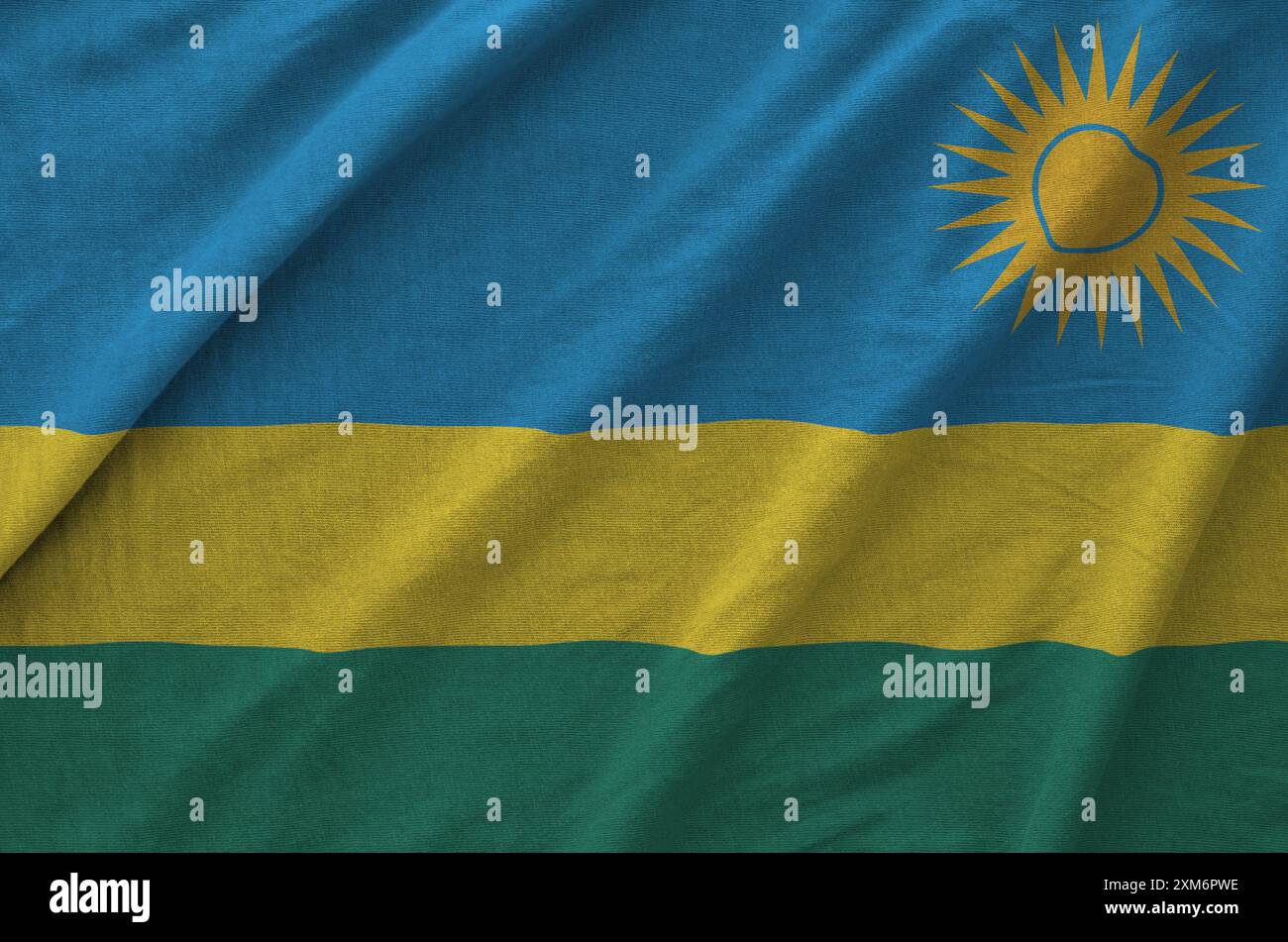 Rwanda flag depicted on folded wavy fabric of old cloth close up Stock ...