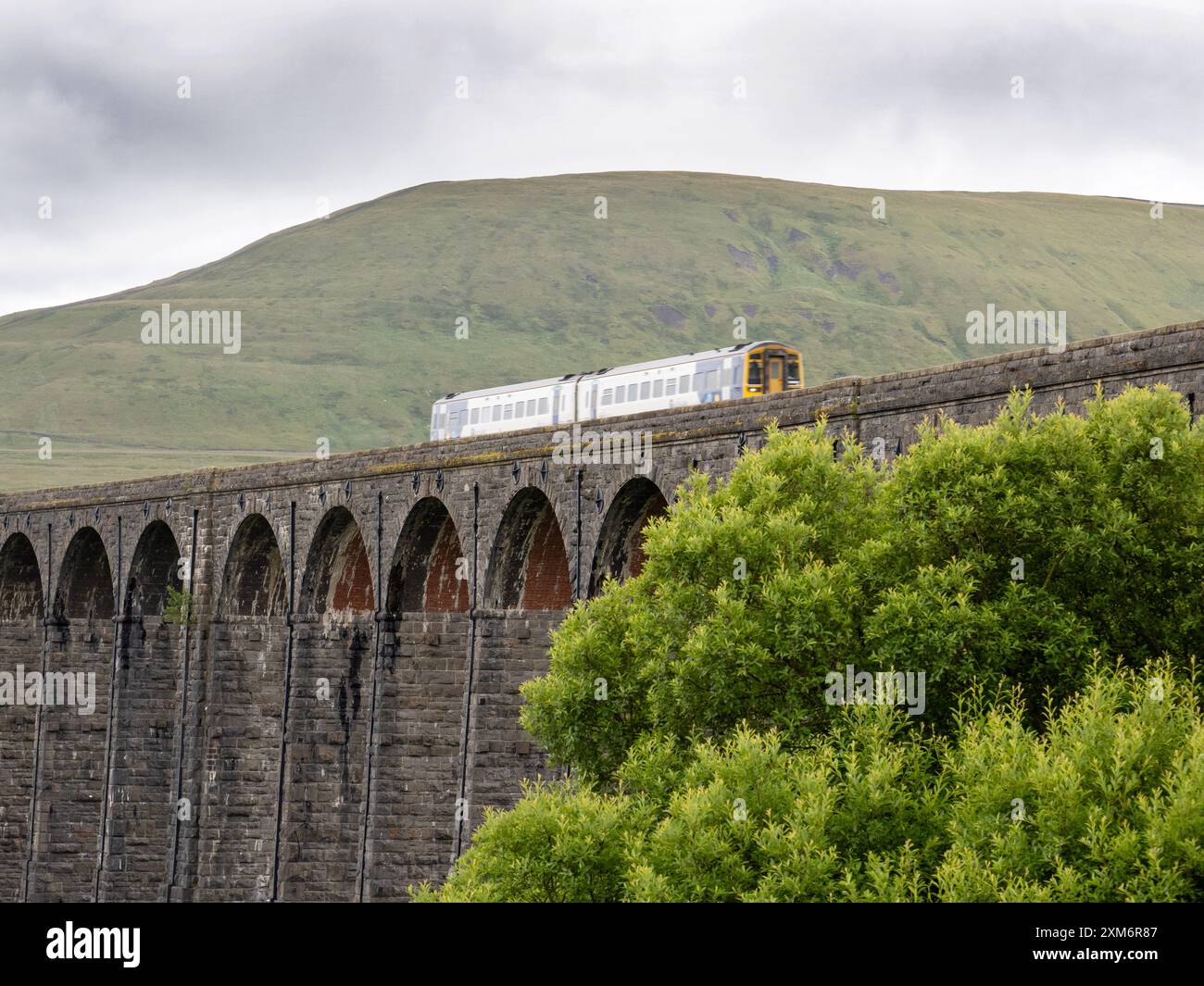 A train crossing Ribble Head viaduct below Ingleborough, Yorkshire ...