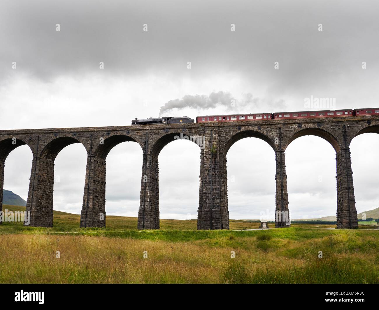 A steam train crossing the famous Ribblehead viaduct on the Settle ...