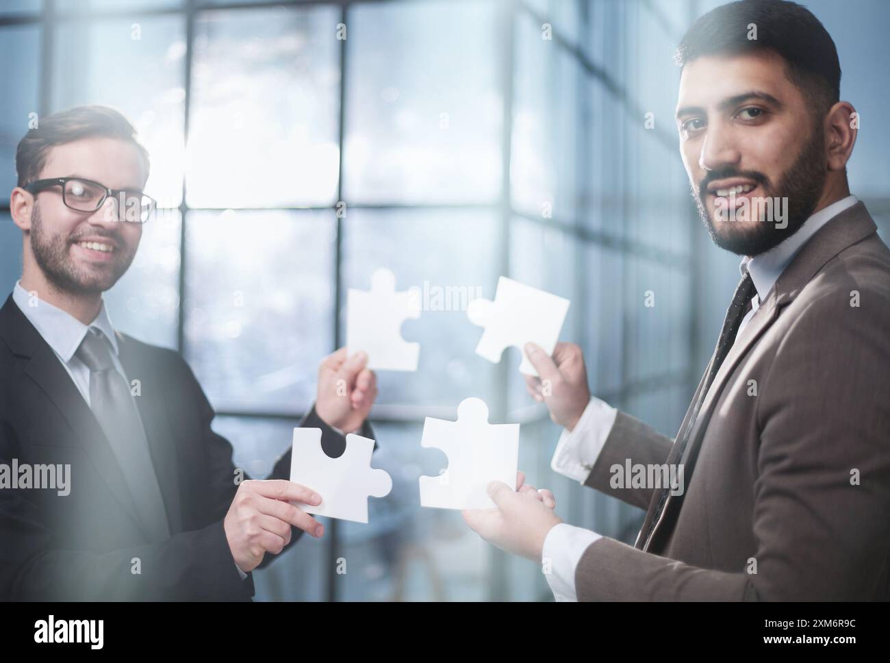 Working together to put things together. two unrecognizable ...