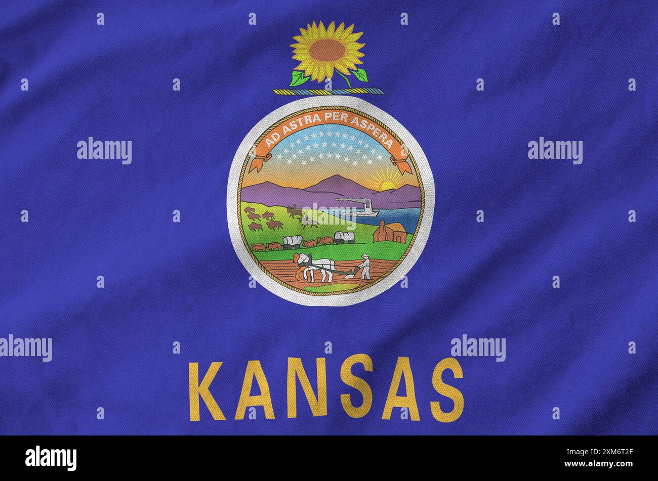 Kansas US state flag depicted on folded wavy fabric of old cloth close ...