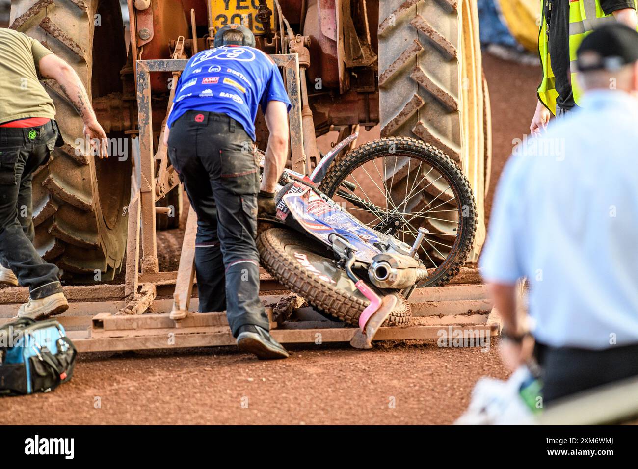 Belle Vue Aces' Dan Bewley 's damaged bike is taken back to the pits ...