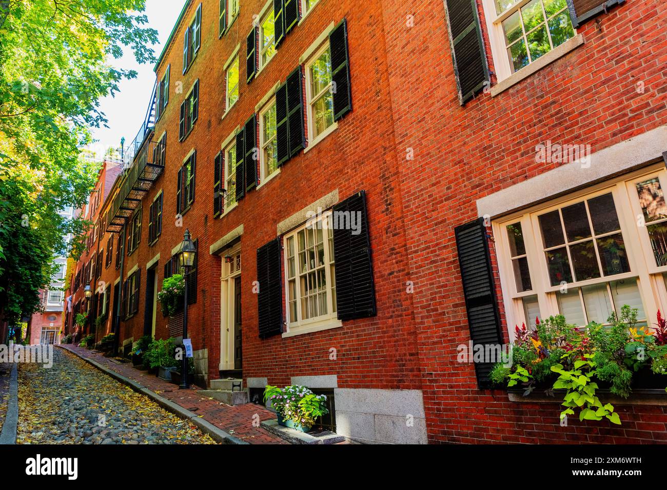 View up the narrow cobblestoned Acorn Street and its row of townhouses ...