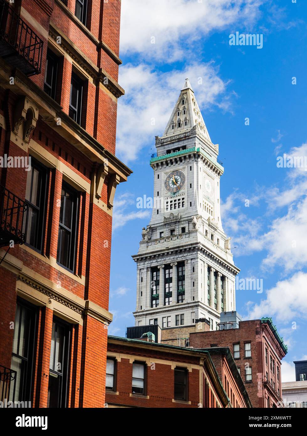 Boston's Custom House tower viewed past brick buildings Stock Photo - Alamy