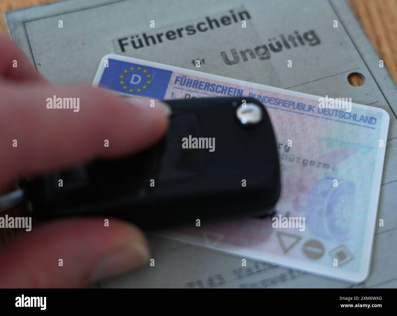 ILLUSTRATION - 23 July 2024, Hesse, Frankfurt/Main: A hand reaches for ...