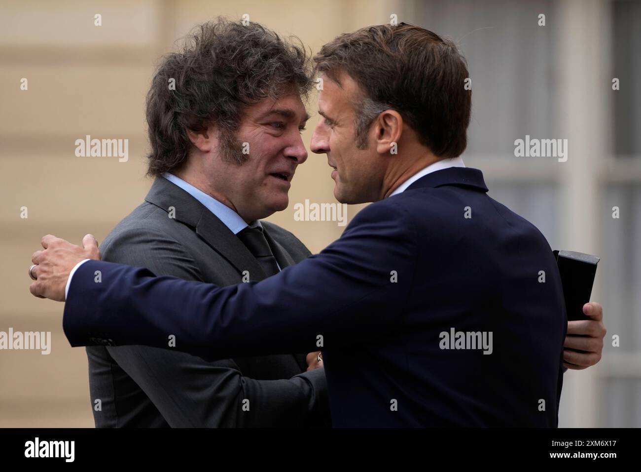 French President Emmanuel Macron, right, hugs Argentina's President ...