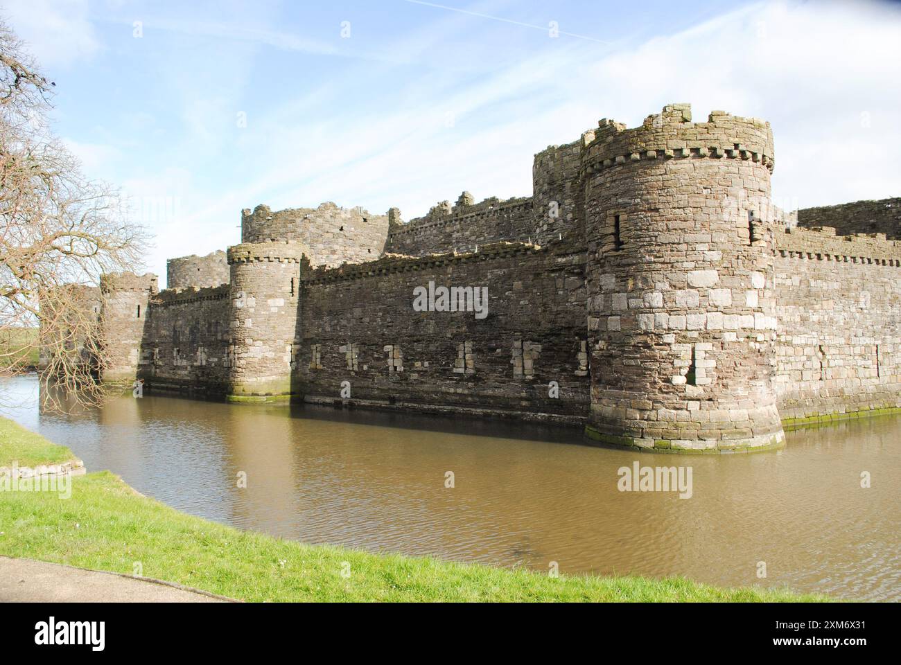Beaumaris castle Anglesey wales with view over Snowdonia mountain range ...
