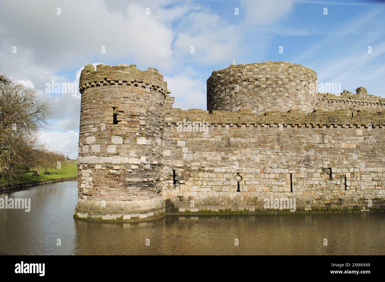 Beaumaris castle Anglesey wales with view over Snowdonia mountain range ...
