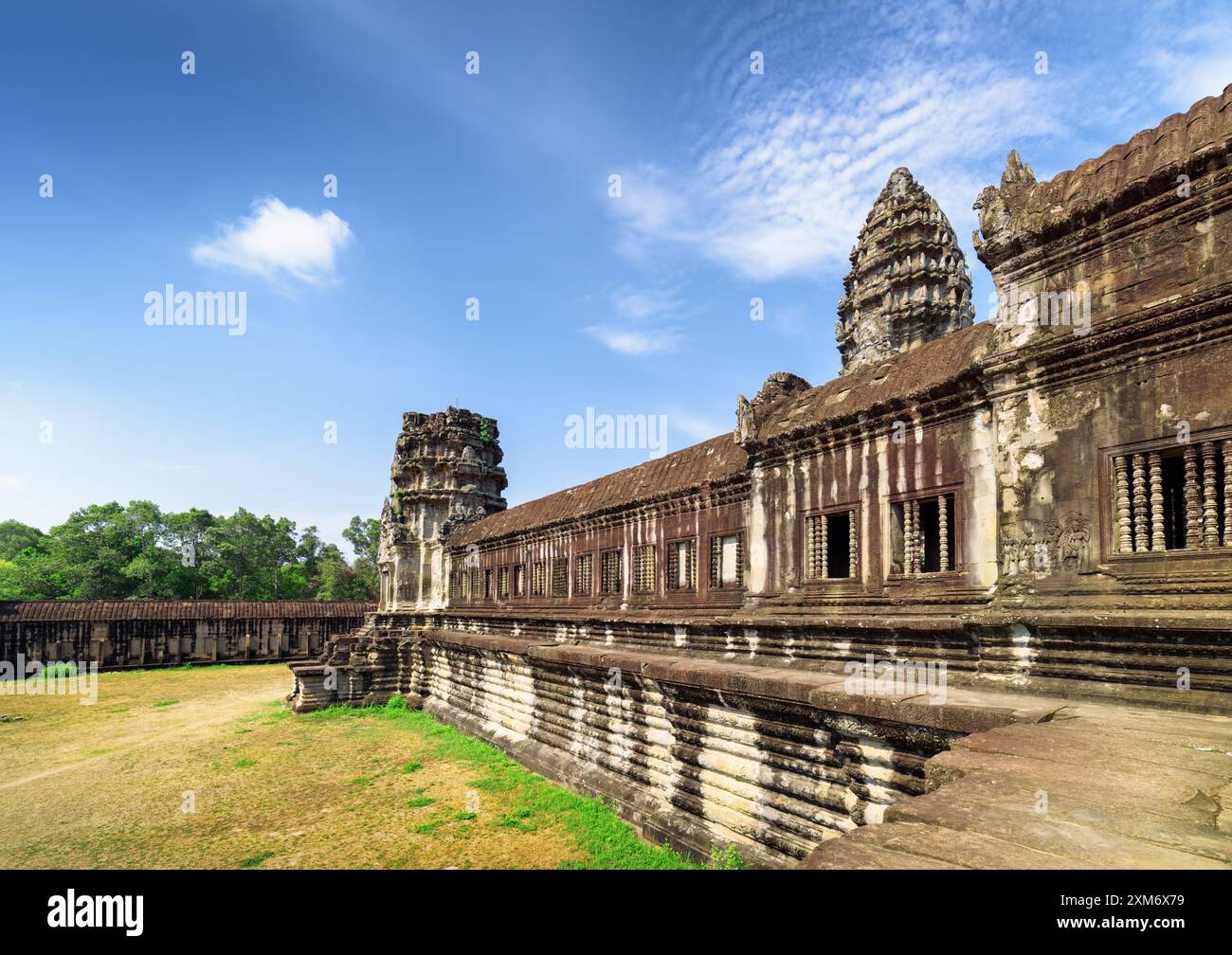 Wall of gallery and one of towers Angkor Wat temple, Cambodia Stock ...