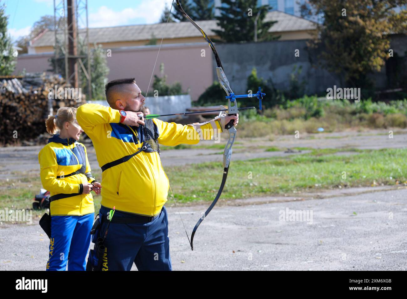 Training. Man archer aiming a bow on an archery shooting range. October ...