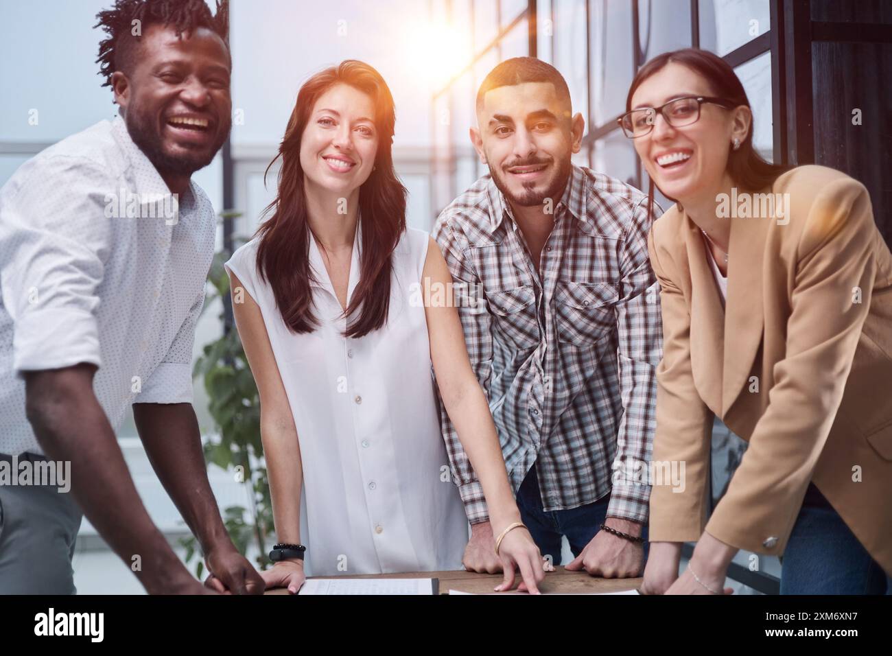 Diverse business groups stand around a meeting table Stock Photo - Alamy