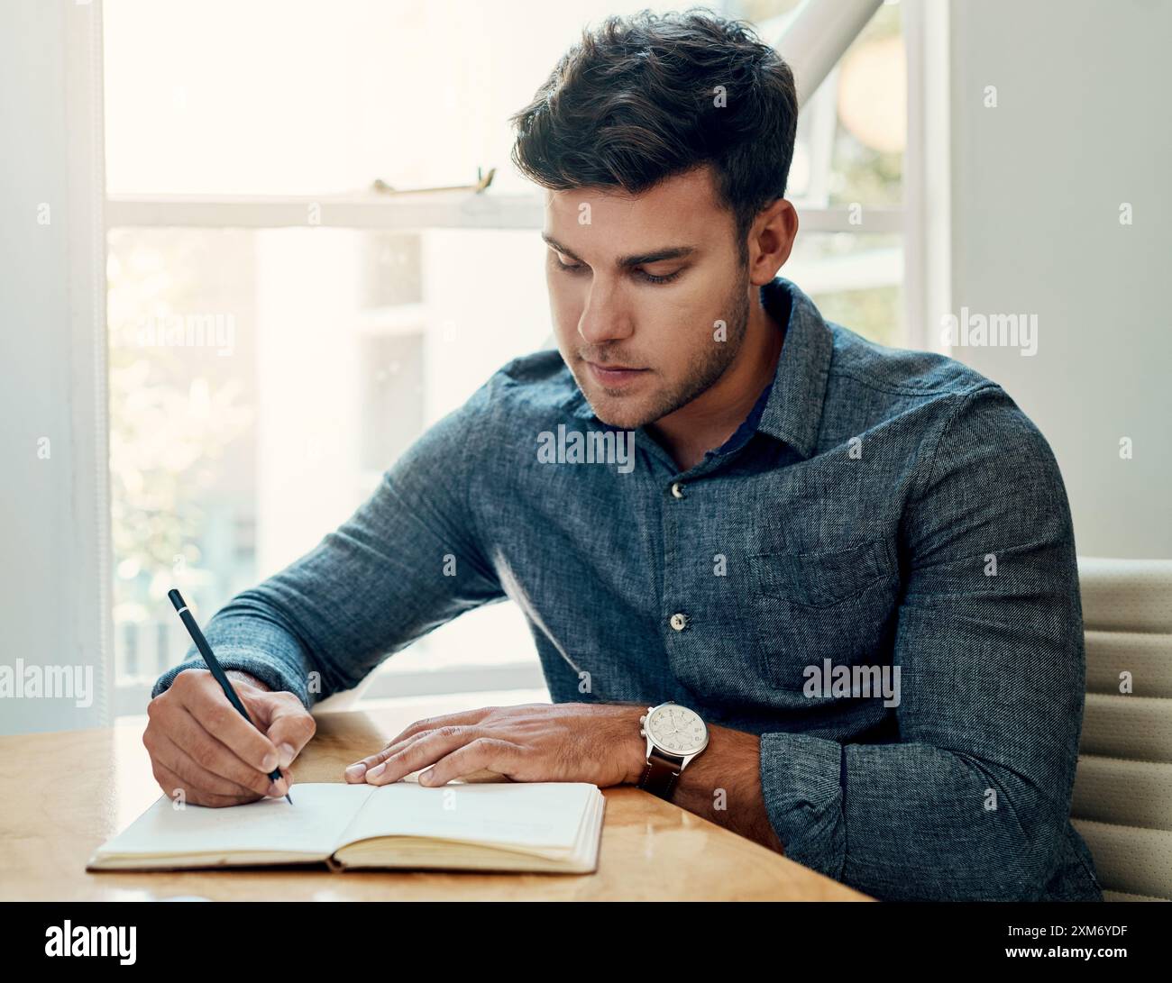 Creative, man and writing on book in office with notes of schedule ...