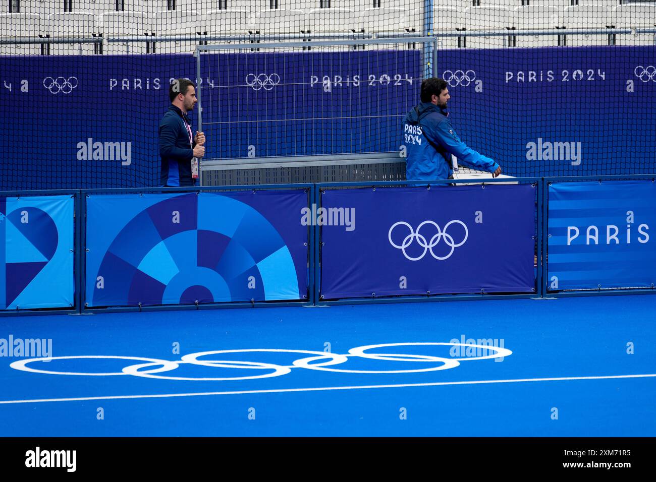 Ground staff make final arrangements for the opening match of field ...