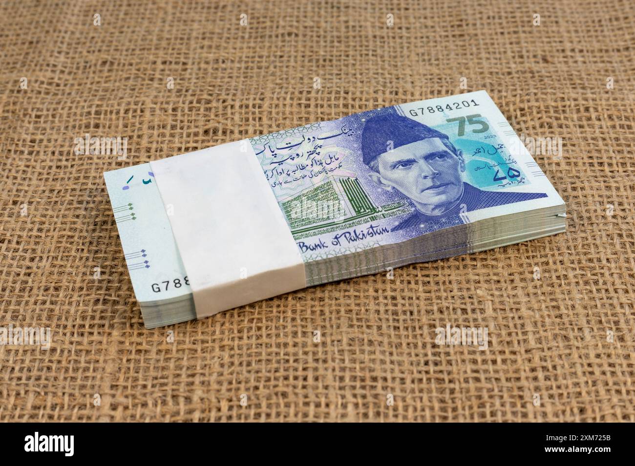 Stack of 75 Pakistani Rupees Banknotes on Burlap Surface Stock Photo ...