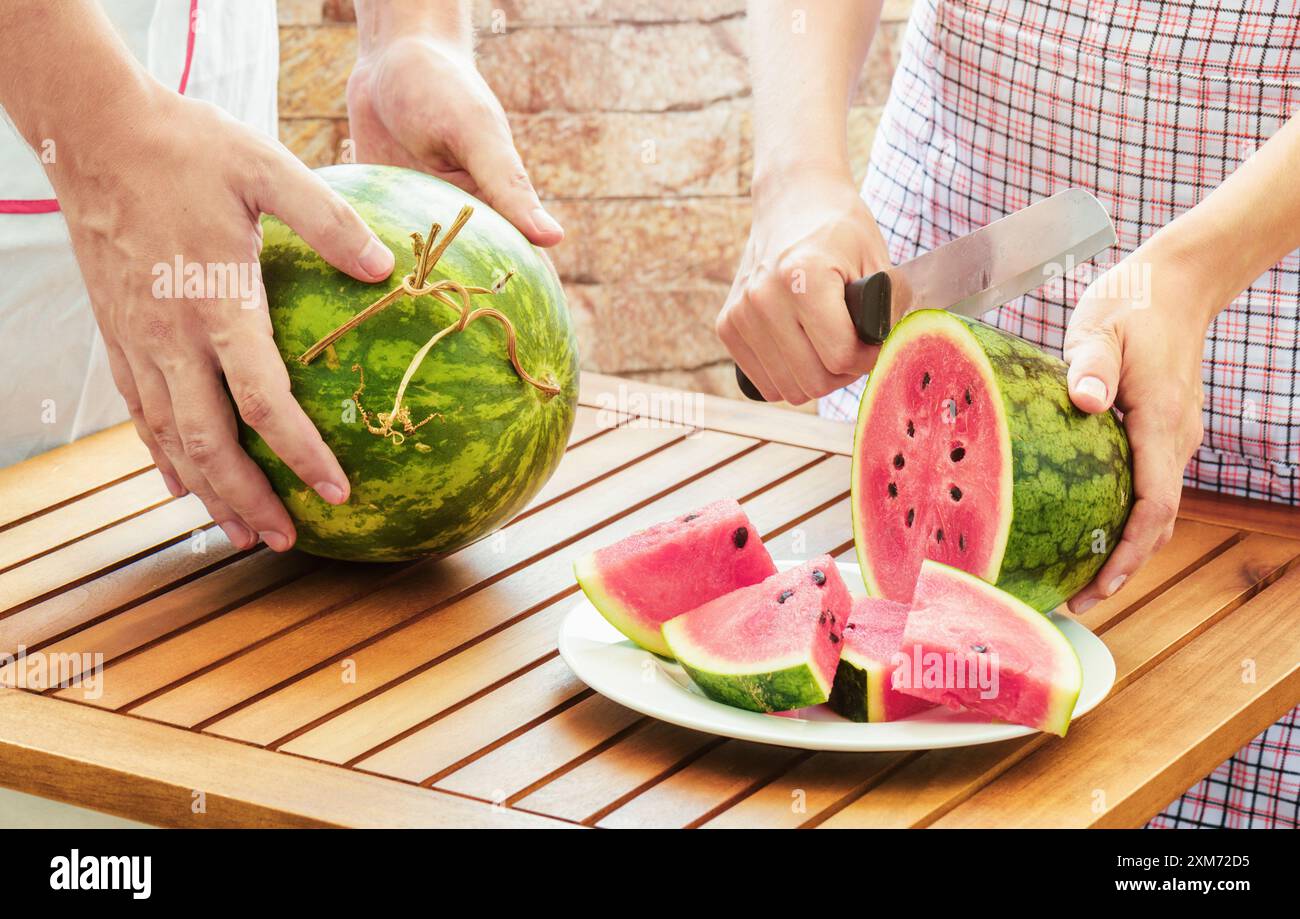 Woman in apron cutting red hi-res stock photography and images - Alamy