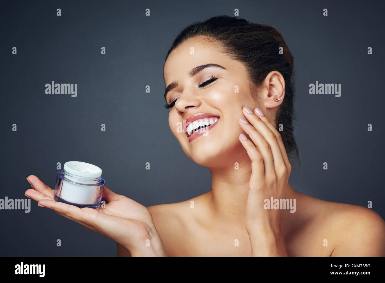 Cream, application and skincare of woman in studio, healthy skin and ...
