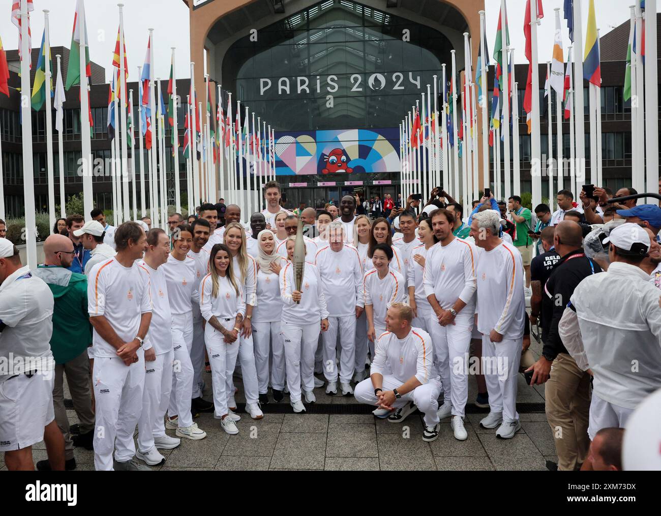 Paris, France. 26th July, 2024. Torchbearers pose for group photos ...