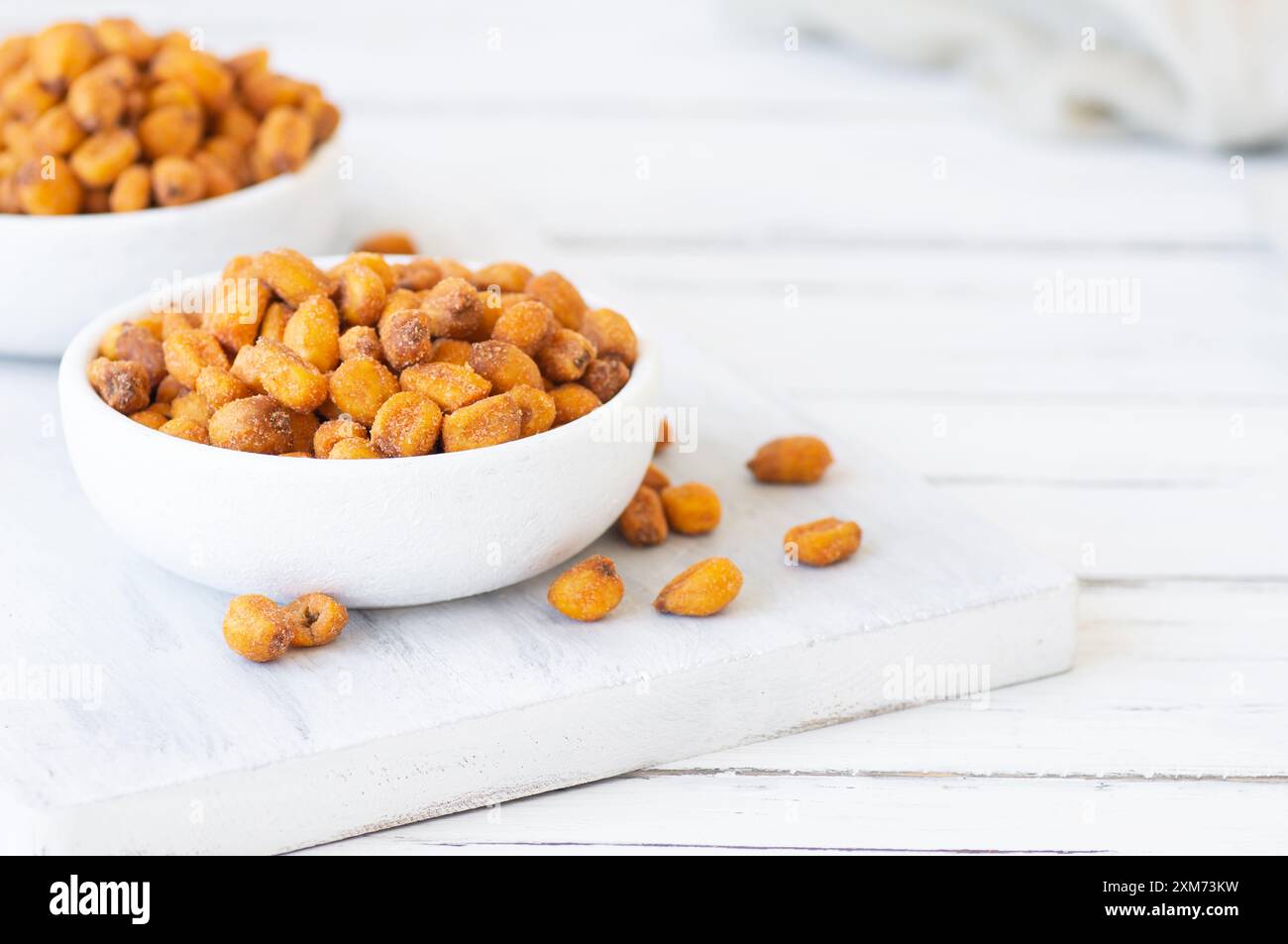 Roasted salted Corn Nuts with Spice and Sauce in bowl on rustic table, Nut concept Stock Photo ...