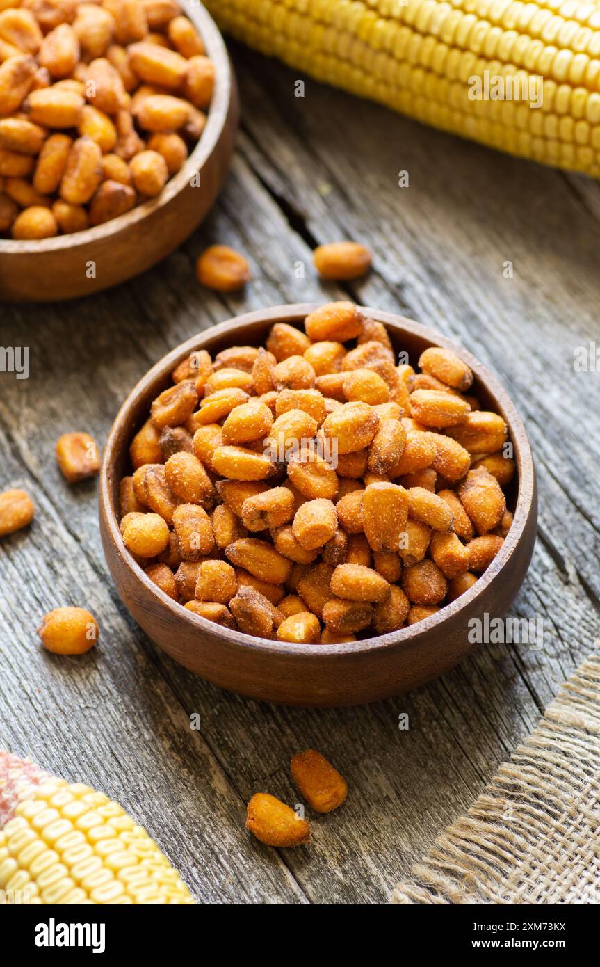 Roasted salted Corn Nuts with Spice and Sauce in bowl on rustic table ...