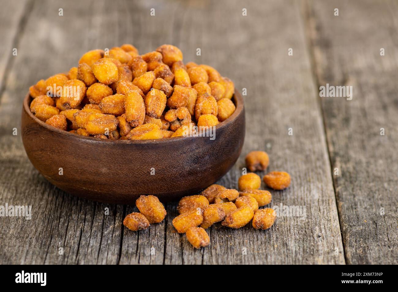 Roasted salted Corn Nuts with Spice and Sauce in bowl on rustic table ...