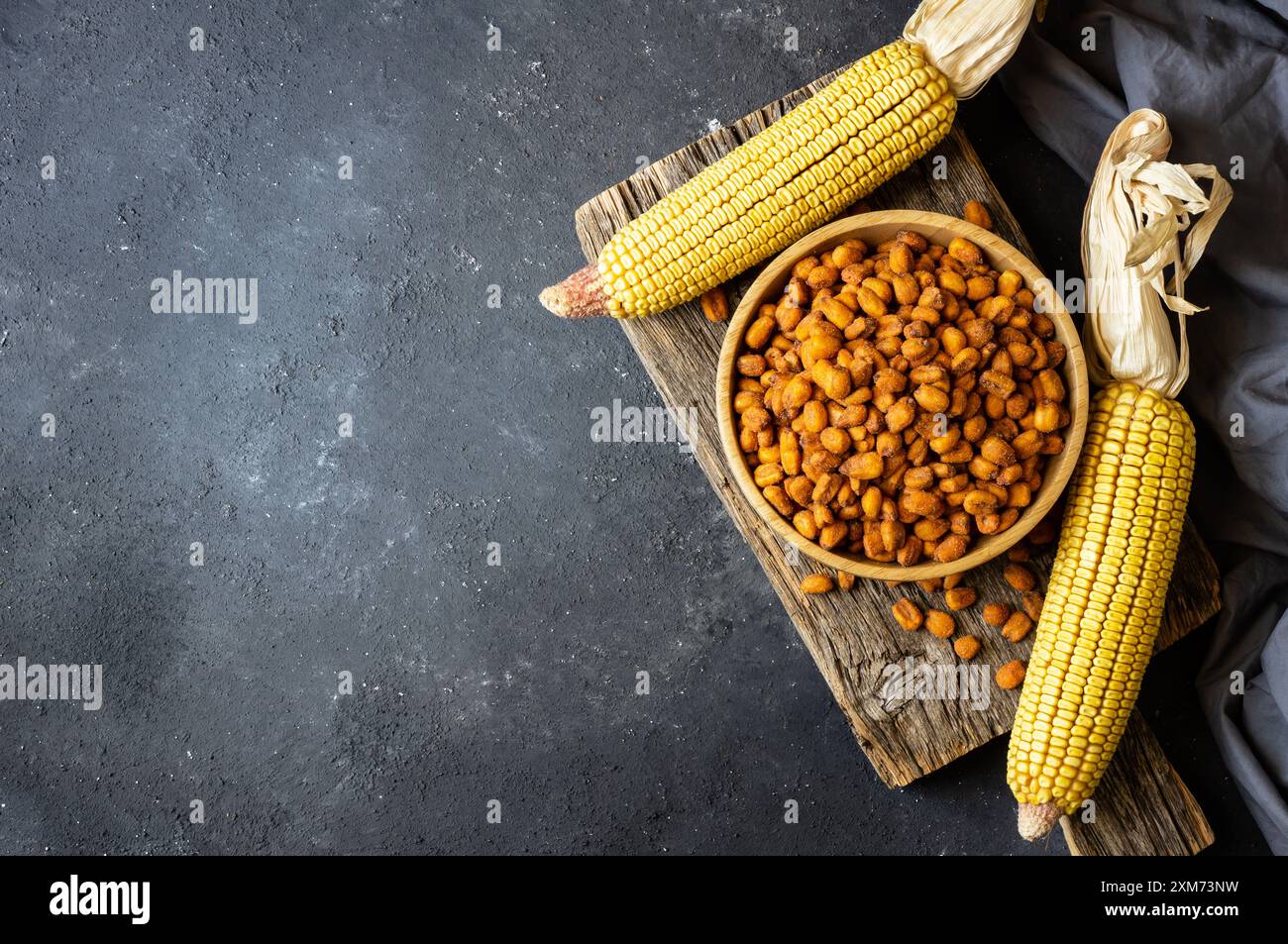 Roasted salted Corn Nuts with Spice and Sauce in bowl on rustic table ...