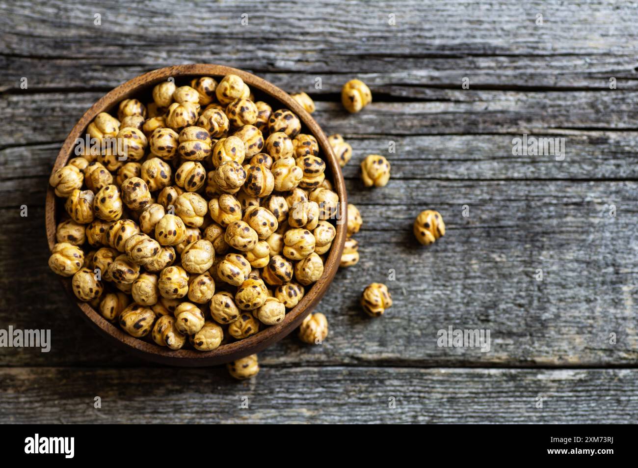 Roasted yellow chickpeas in bowl on rustic background, traditional ...