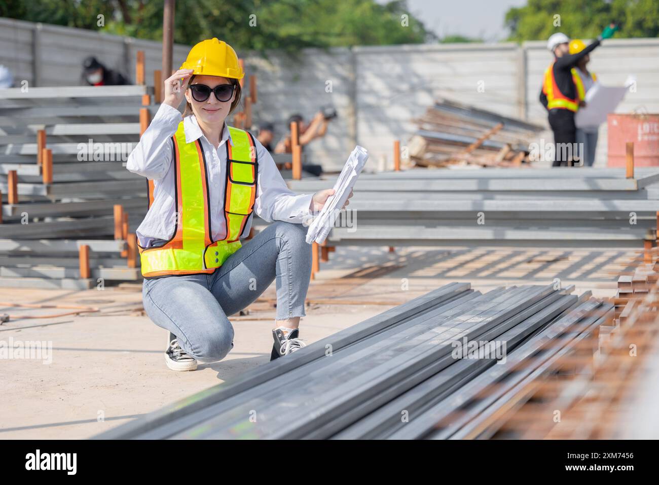 Young female construction worker with hard hat and safety vest ...