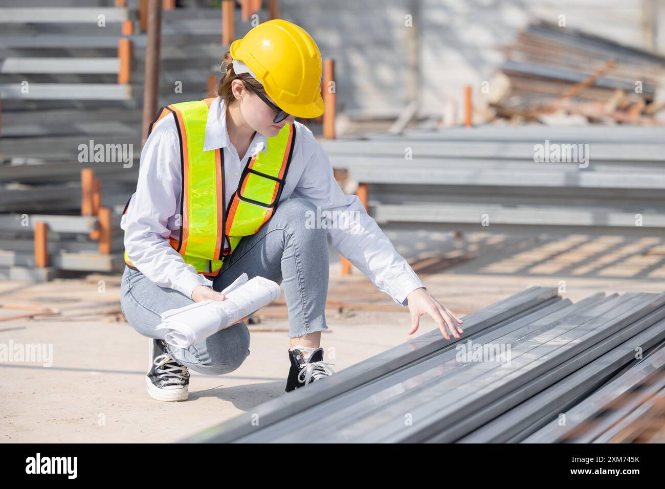 Young female construction worker with hard hat and safety vest ...