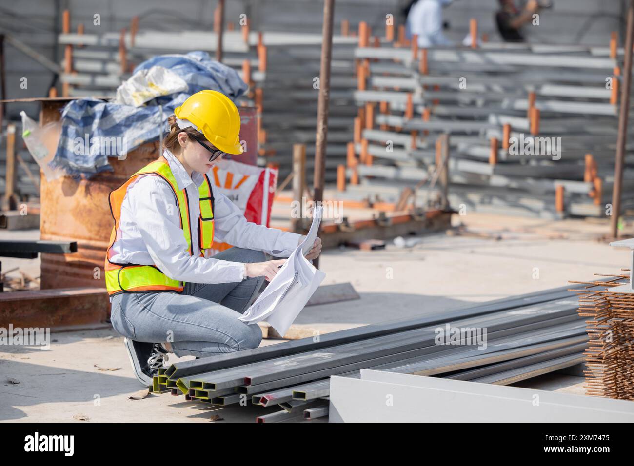 Young female construction worker with hard hat and safety vest ...