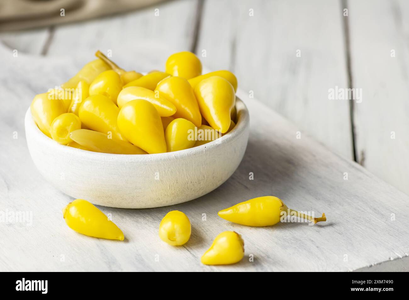 Fresh yellow chubby hot pepper pickle in bowl, marinated or canned ...