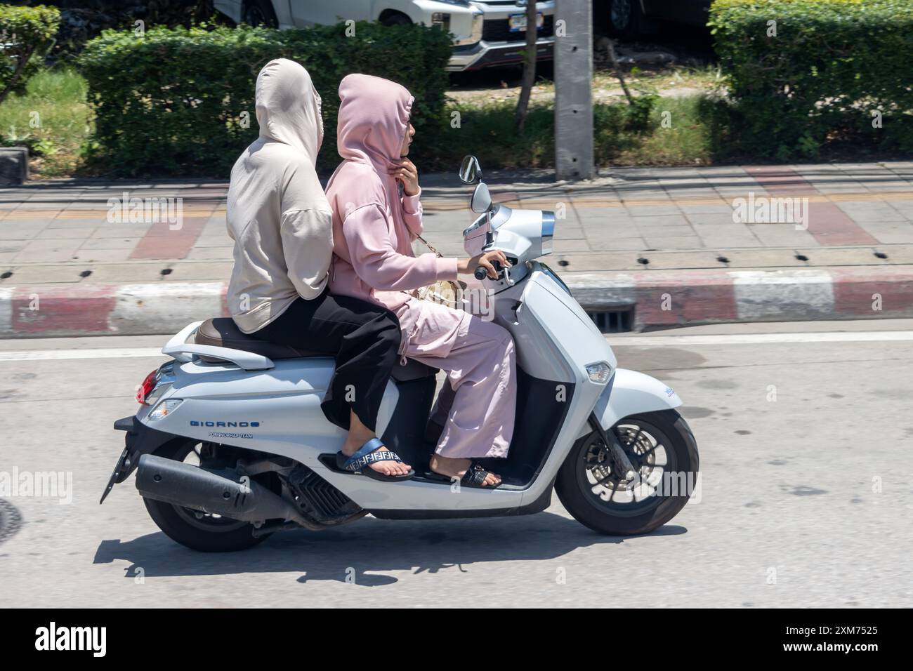 BANGKOK, THAILAND, JUNE 16 2024, A couple is riding a motorcycle in the ...