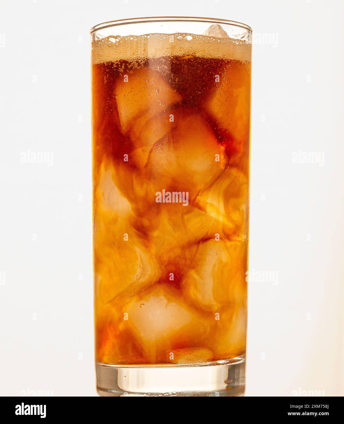 vodka and coke mixing with ice in tall glass Stock Photo - Alamy