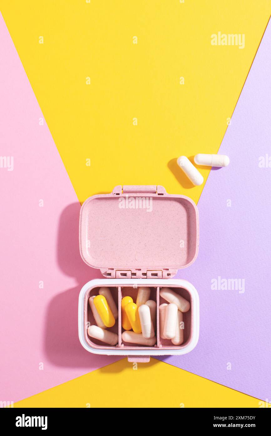 Creative medical and health care composition: open pill box with white ...