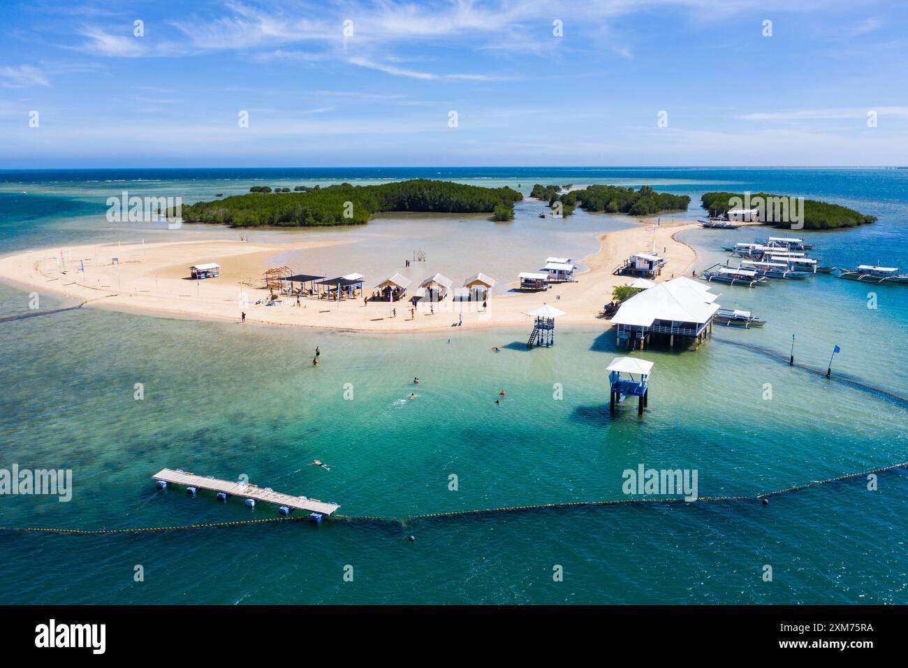 Aerial view of people relaxing on the beach and Bangka outrigger canoe ...