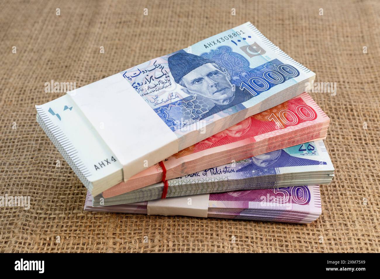 Pakistani currency notes bundle stacked on a burlap background with ...