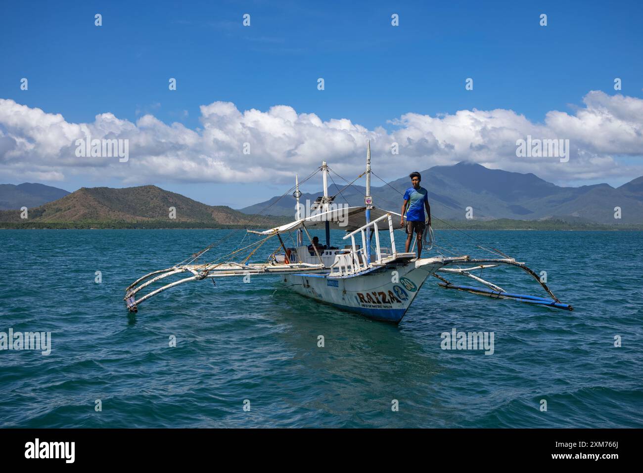 Bangka outrigger canoe tour boat with coast in the distance, Honda Bay ...
