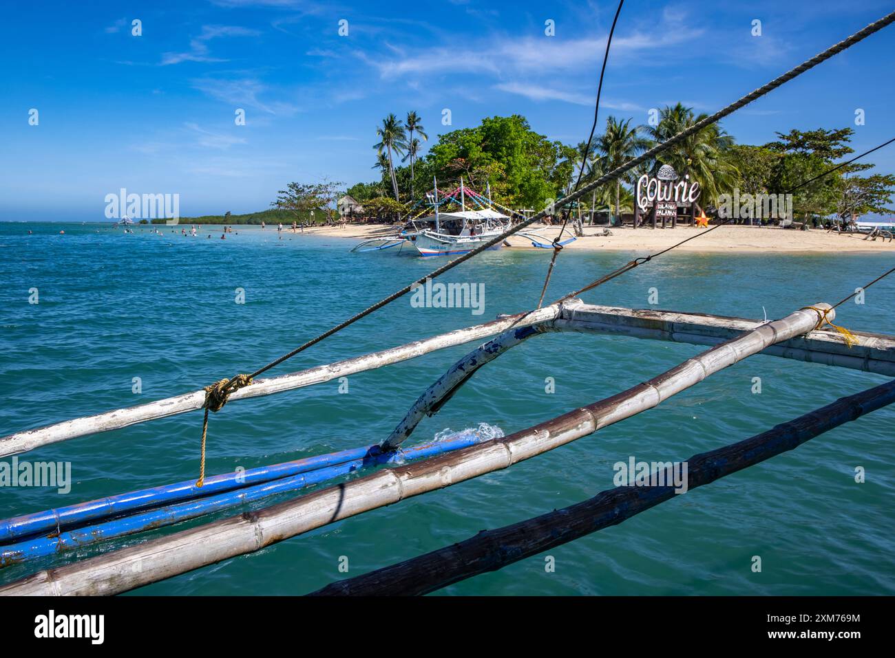 Cowrie Island seen from Bangka outrigger canoe tour boat, Honda Bay ...