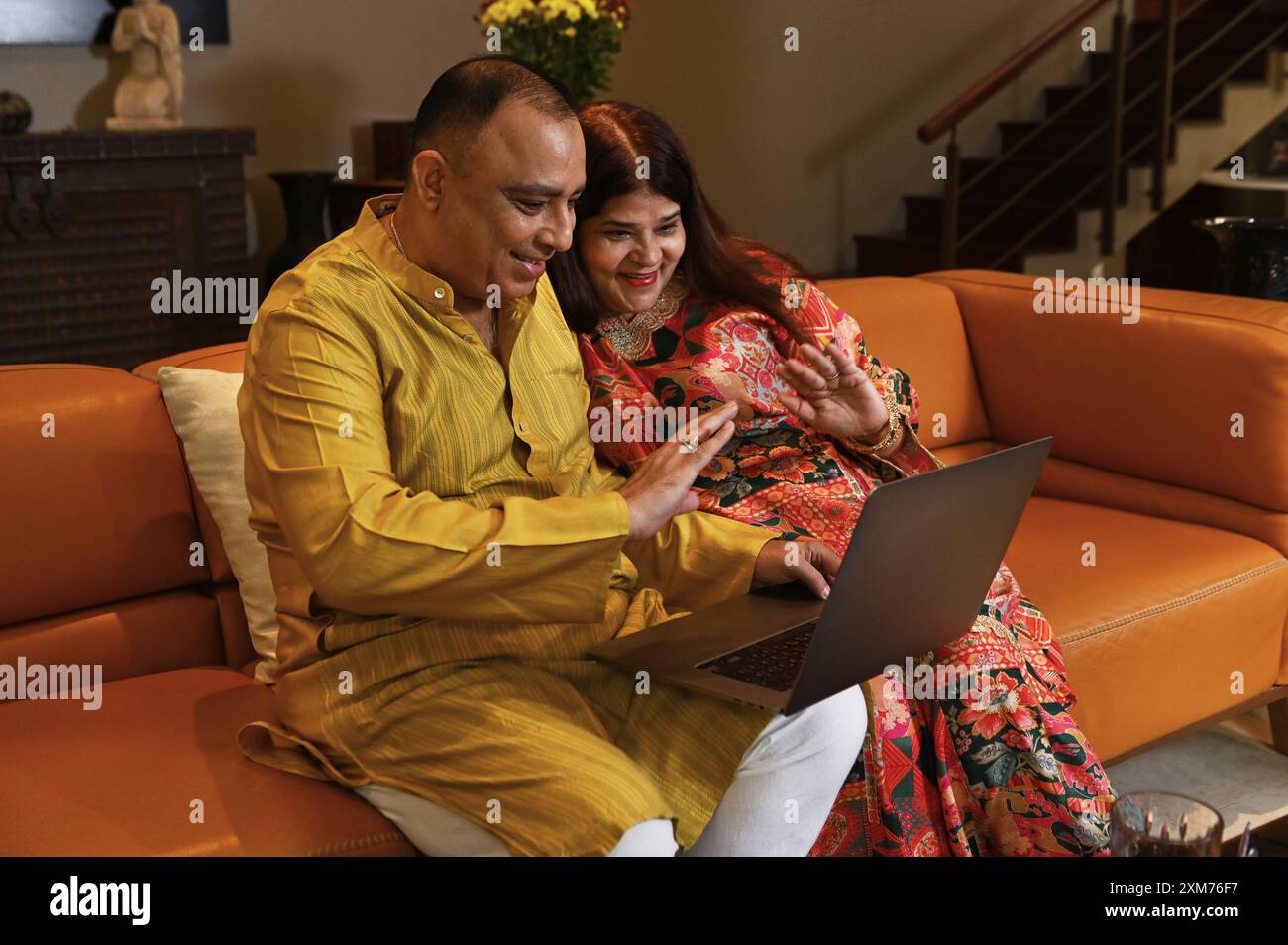Couple Having Online Meeting With Relatives Stock Photo - Alamy