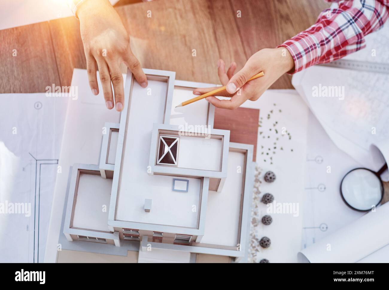 Male architect holding and working on model of architectural house top ...