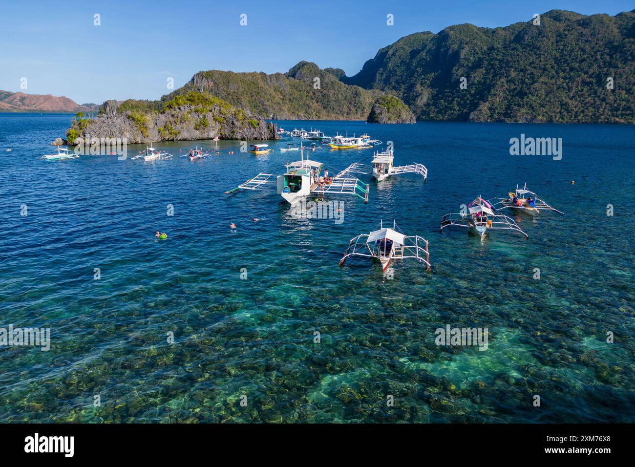Aerial view of Bangka outrigger canoe tour boats and snorkelers in ...