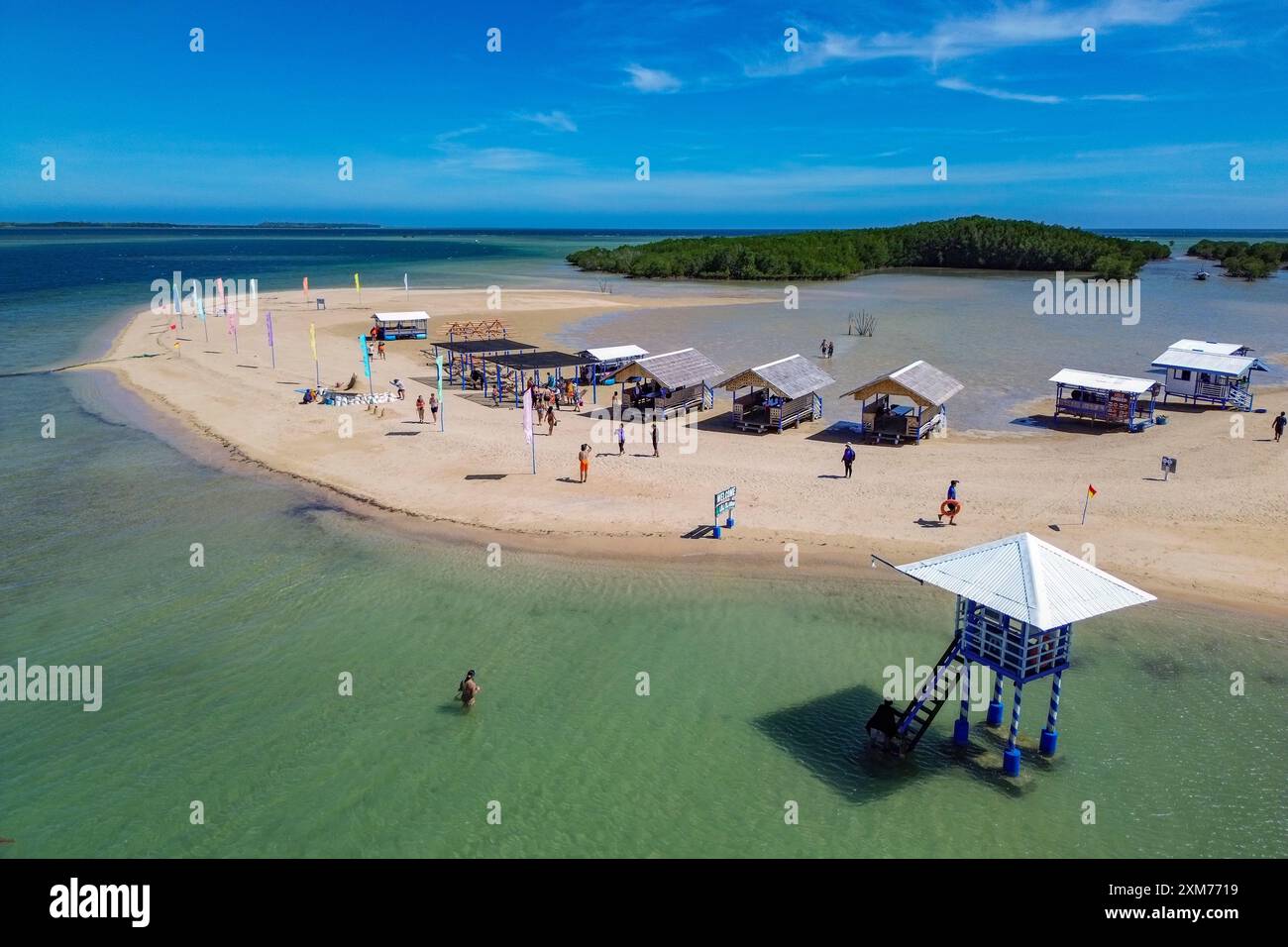 Aerial view of sandbar and people enjoying beach with huts at Luli ...