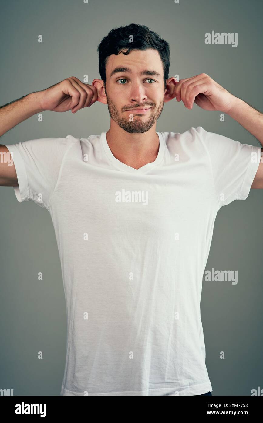 Studio, ear pull and man in tshirt, playful and goofy comedian with ...