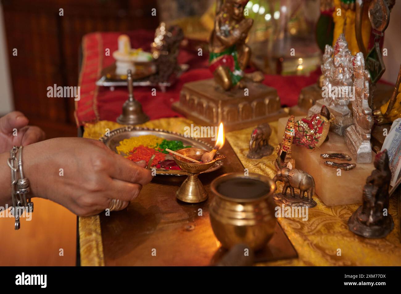 Indian Woman Lightning Candle At Altar Stock Photo - Alamy