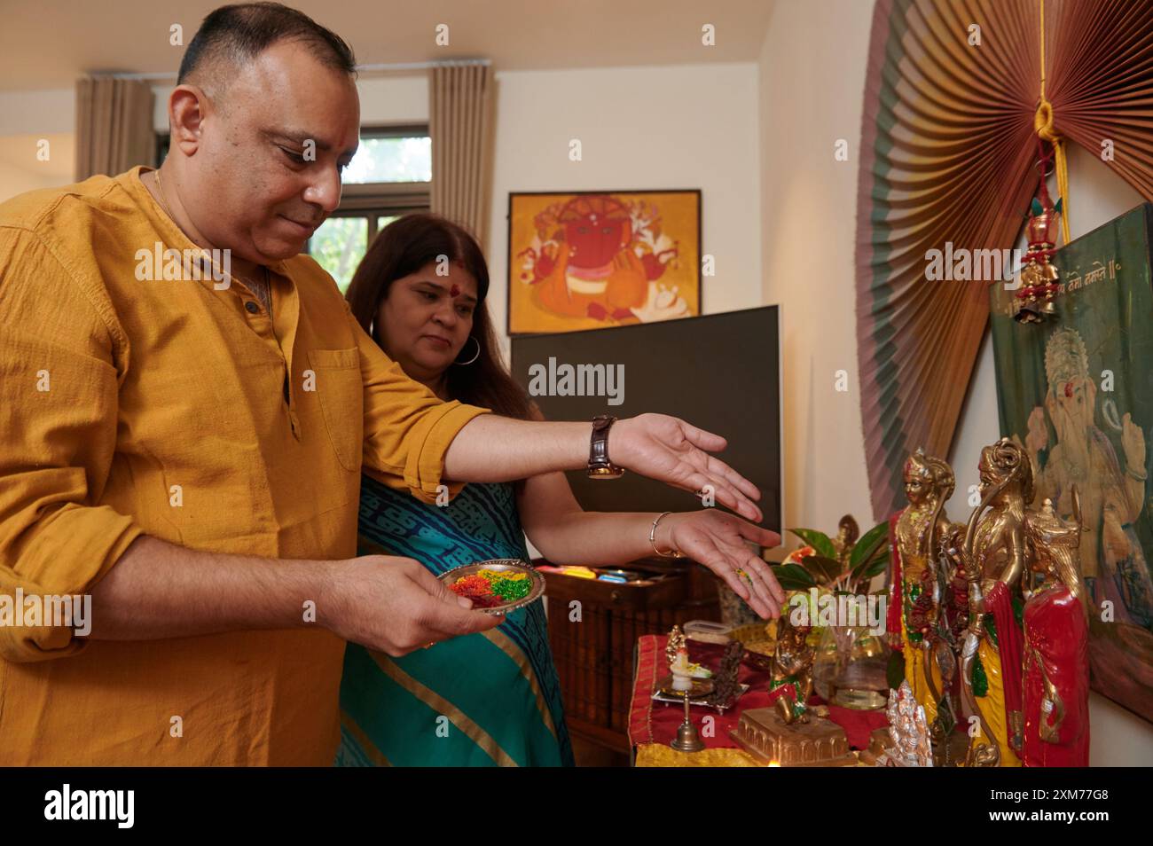 Indian Couple Making Offerings At Altar Stock Photo - Alamy