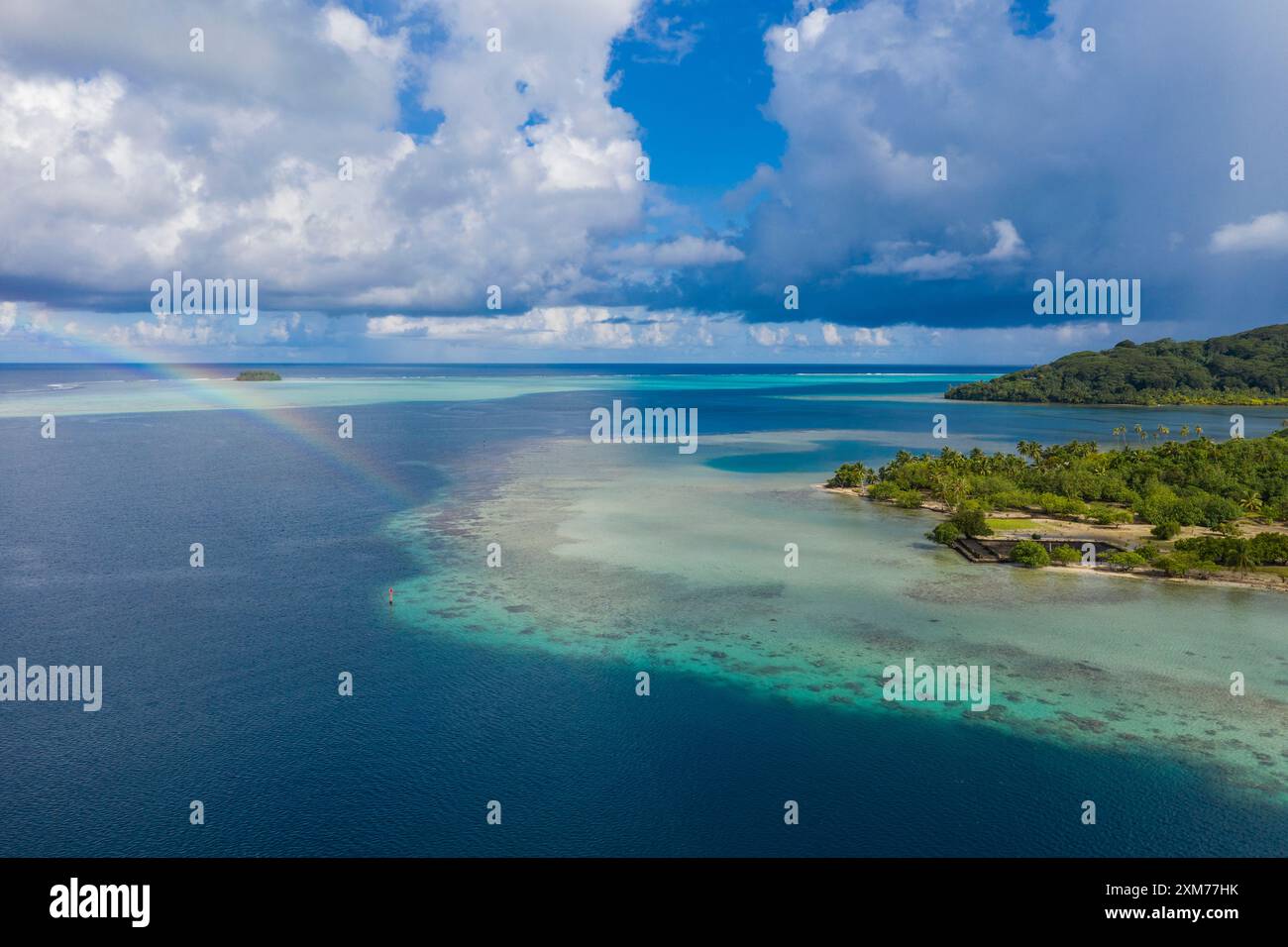 Aerial view of a rainbow on the reef near Marae Taputapuatea, Raiatea ...