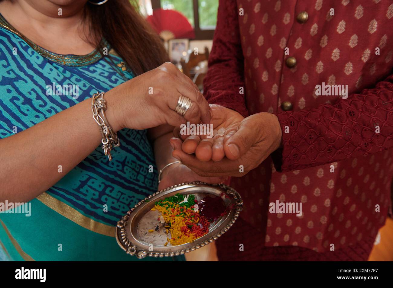 Indian Couple Making Offerings At Altar Stock Photo - Alamy