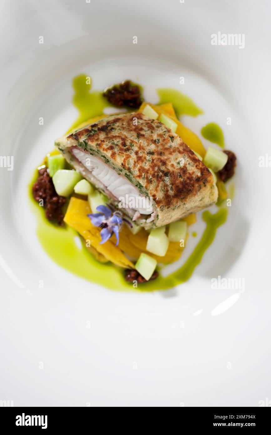 Pike-perch fillet in a herb crust on a bed of vegetables Stock Photo ...
