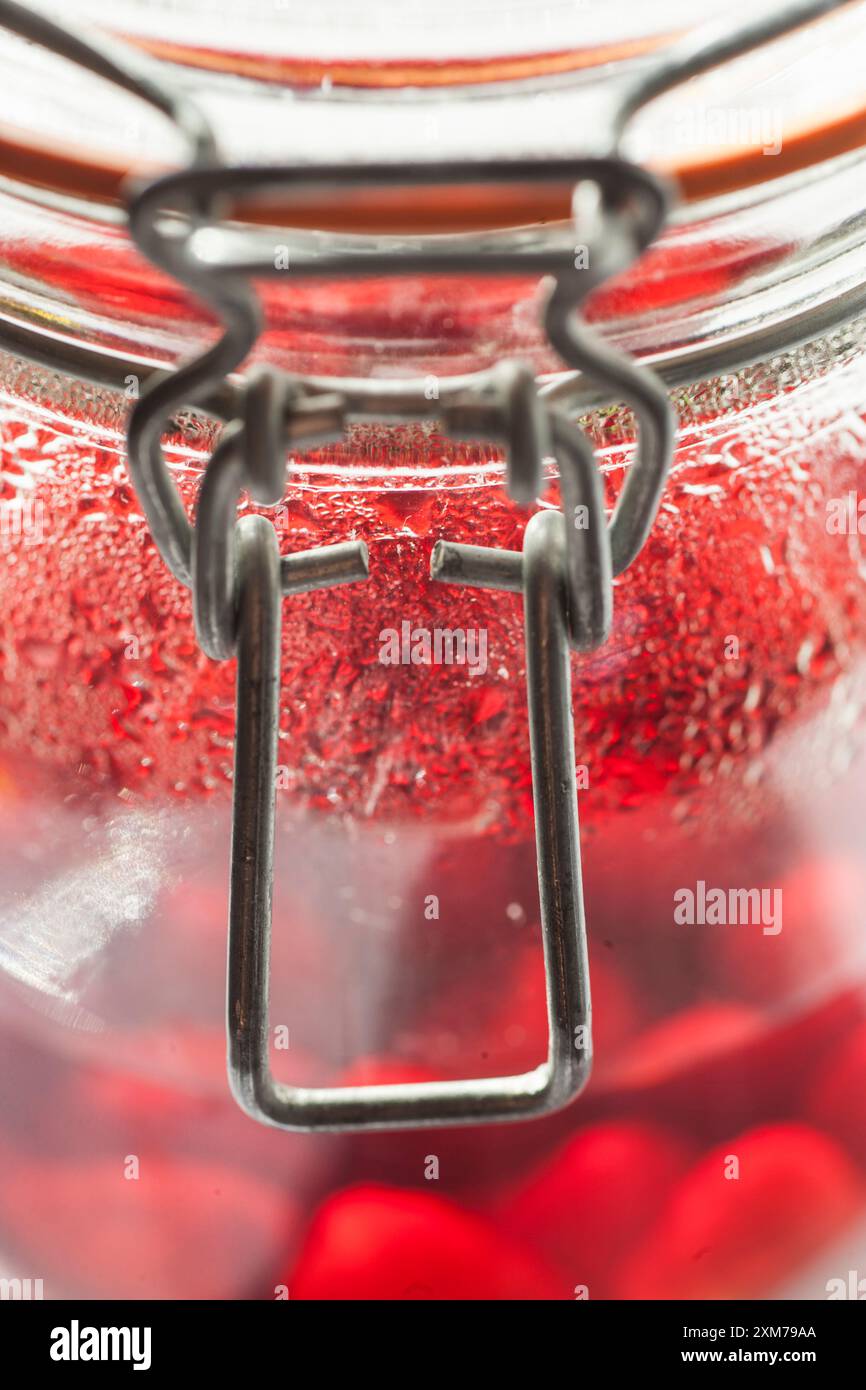 Raspberry schnapps preparation in a glass jar Stock Photo - Alamy