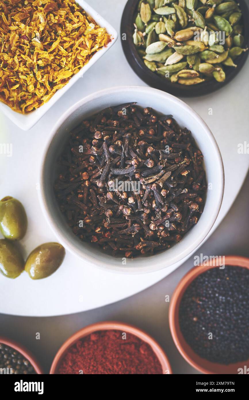 Top view, bowl and clove in gray background for spices, powder and ...