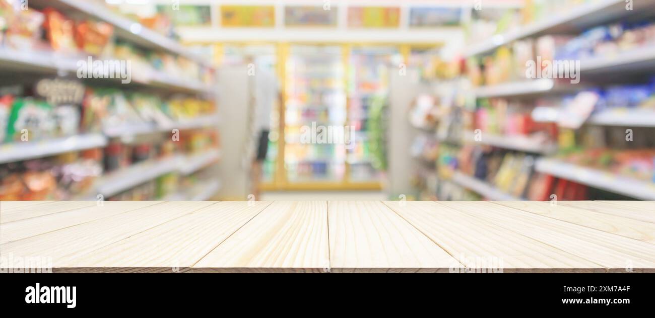 Wood table top with Supermarket convenience store aisle shelves ...